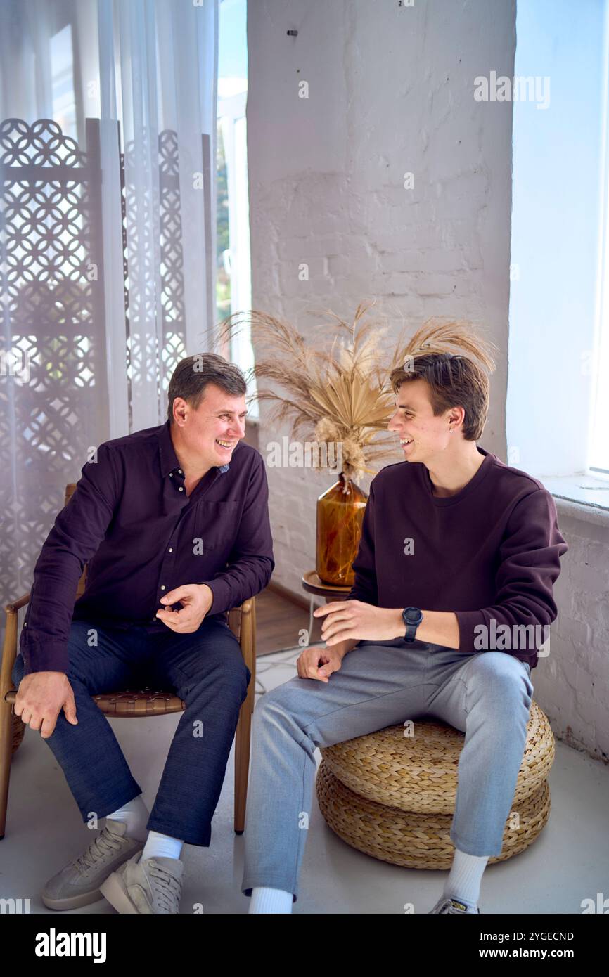 a middle-aged father talking and laughing with his young son Stock ...