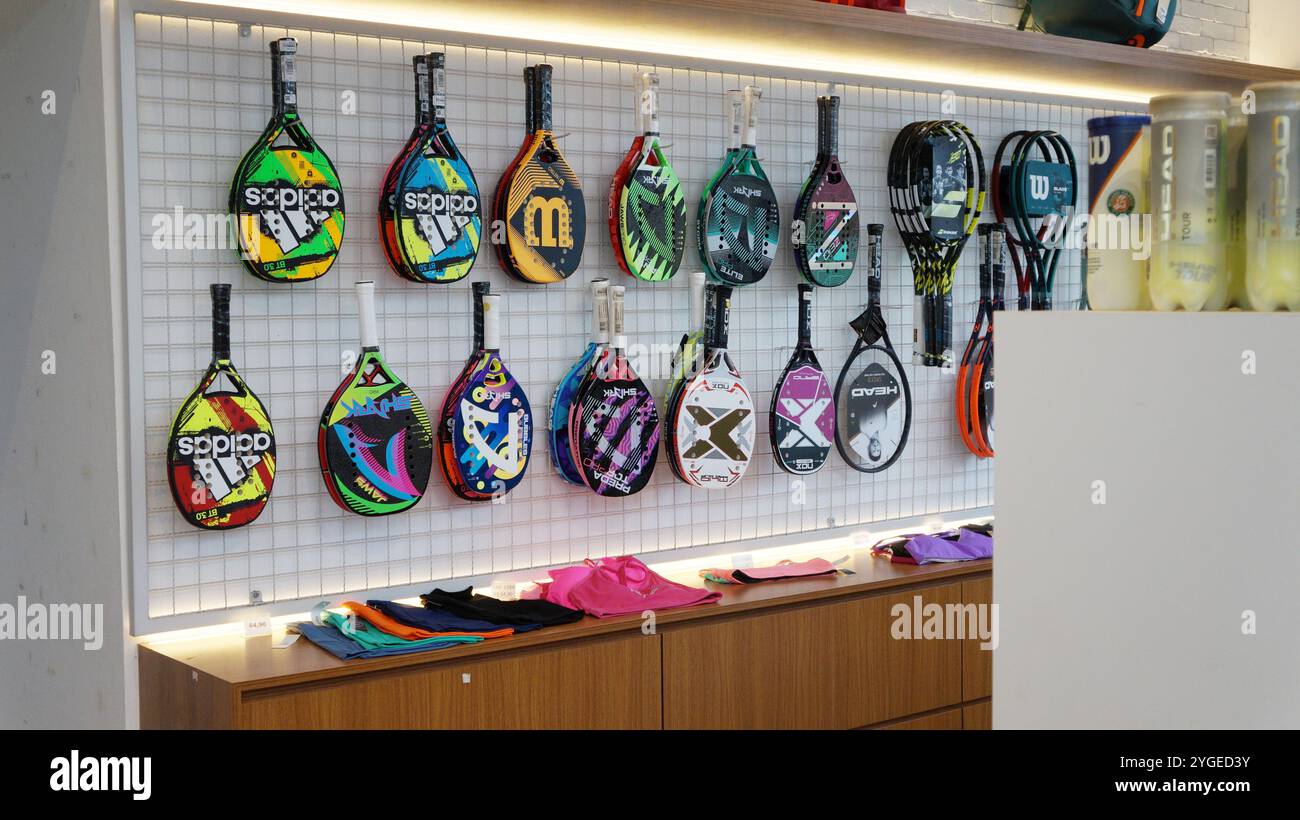 Tennis and beach tennis clothing and rackets display Stock Photo - Alamy