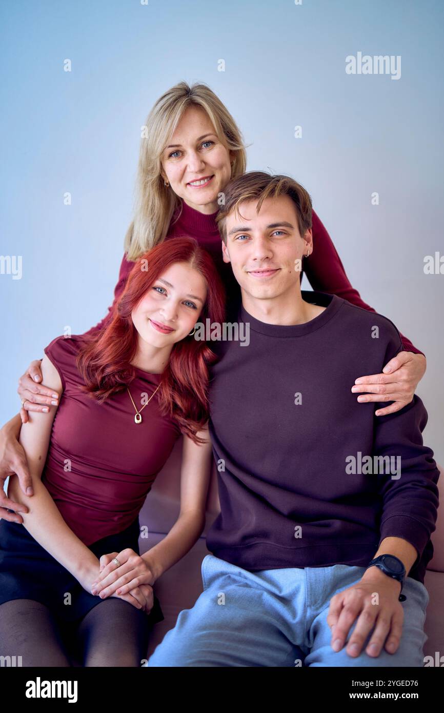 middle-aged mother hugs an adult son and a teenage daughter Stock Photo ...
