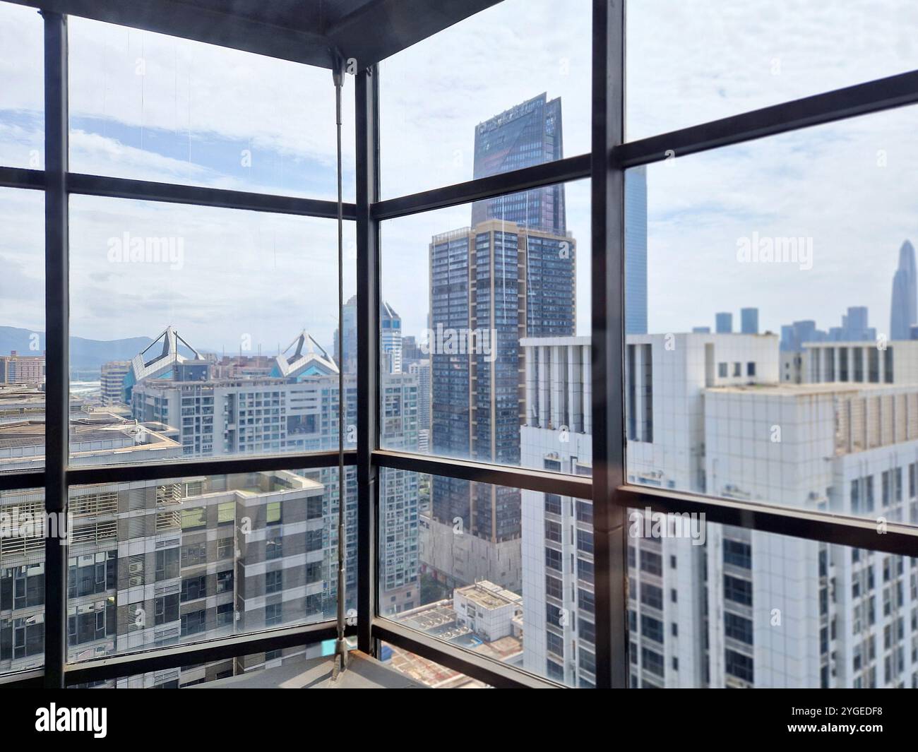 Shenzhen, China - May 10, 2024: Urban view of Shenzhen's modern cityscape seen through large ...