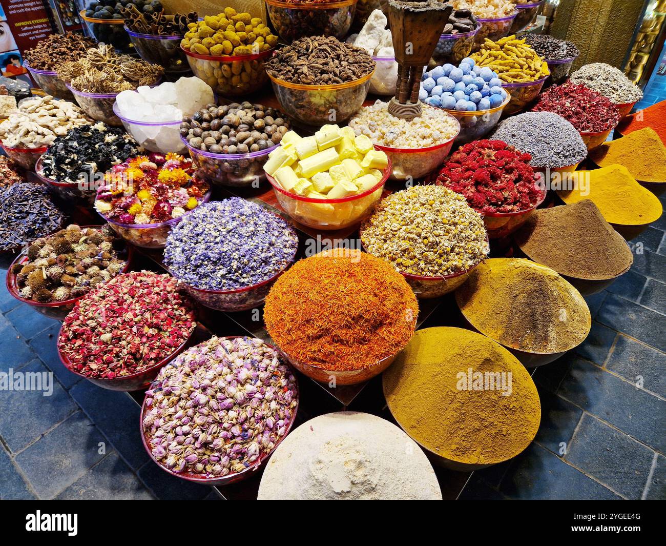 The image displays a vibrant and colorful array of spices and dried ...