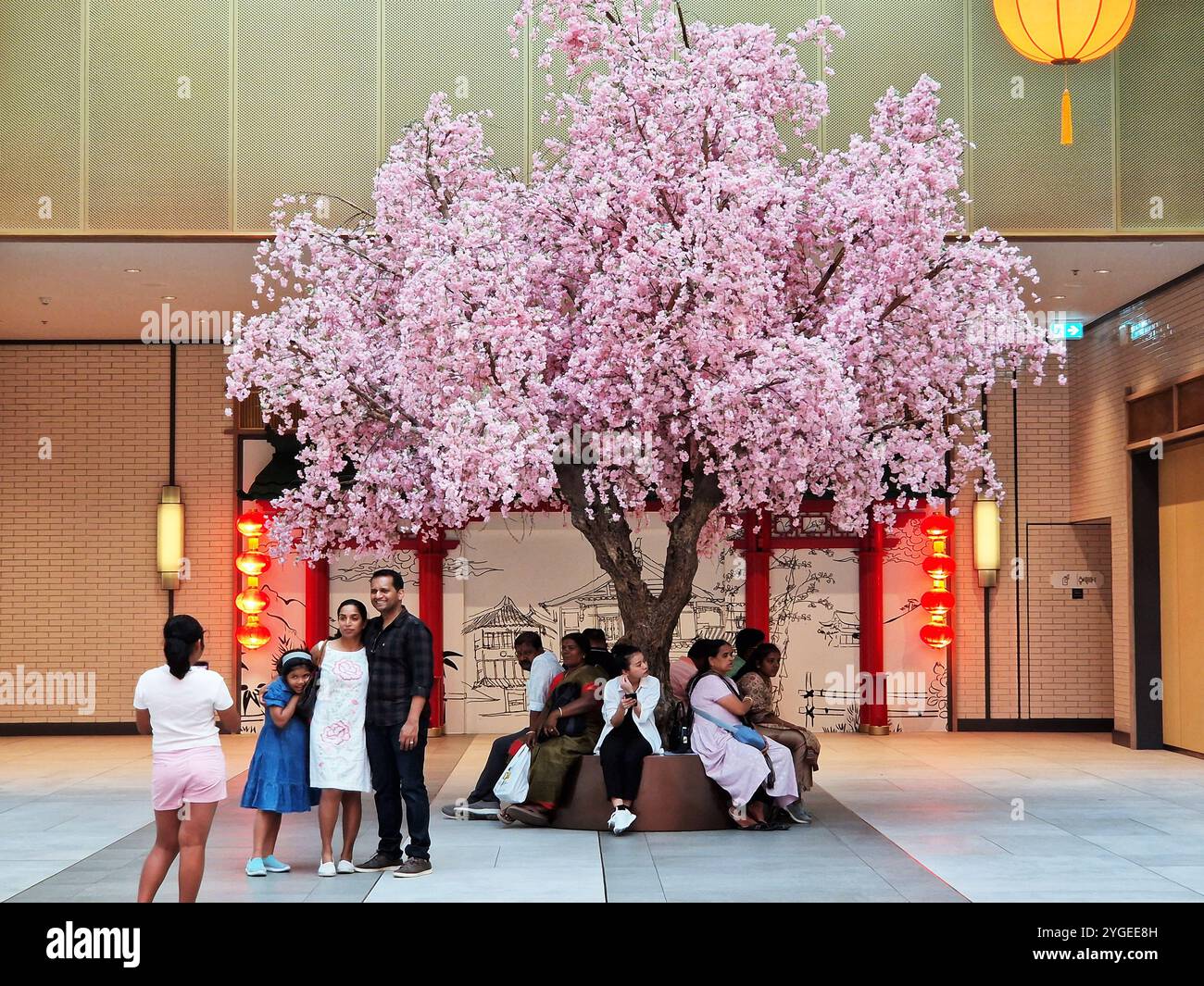 The image features a beautiful artificial cherry blossom tree inside ...