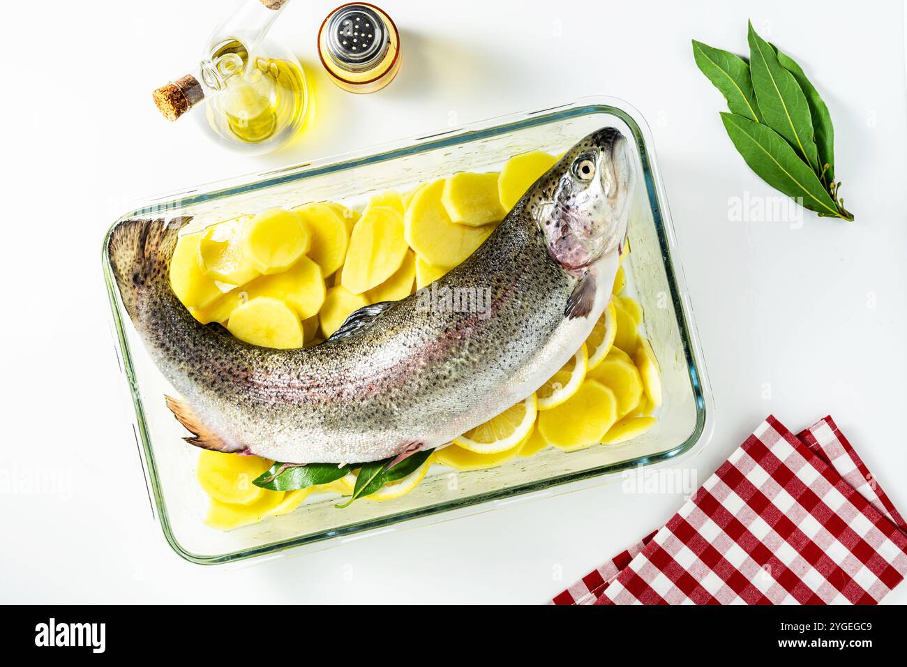 Salmon trout on the baking tray. Baking fish with potatoes Stock Photo ...