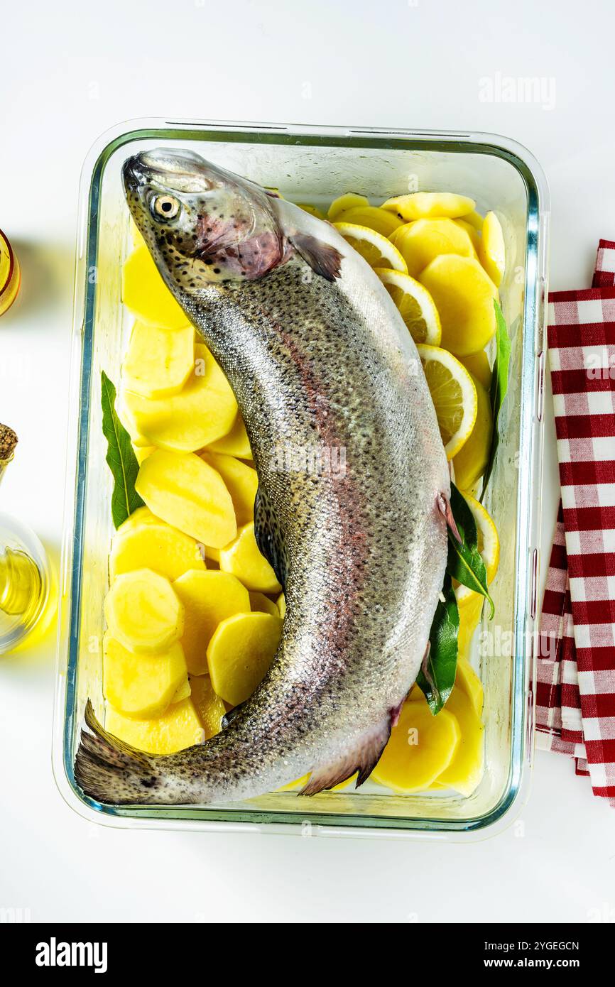 Salmon trout on the baking tray. Baking fish with potatoes Stock Photo ...