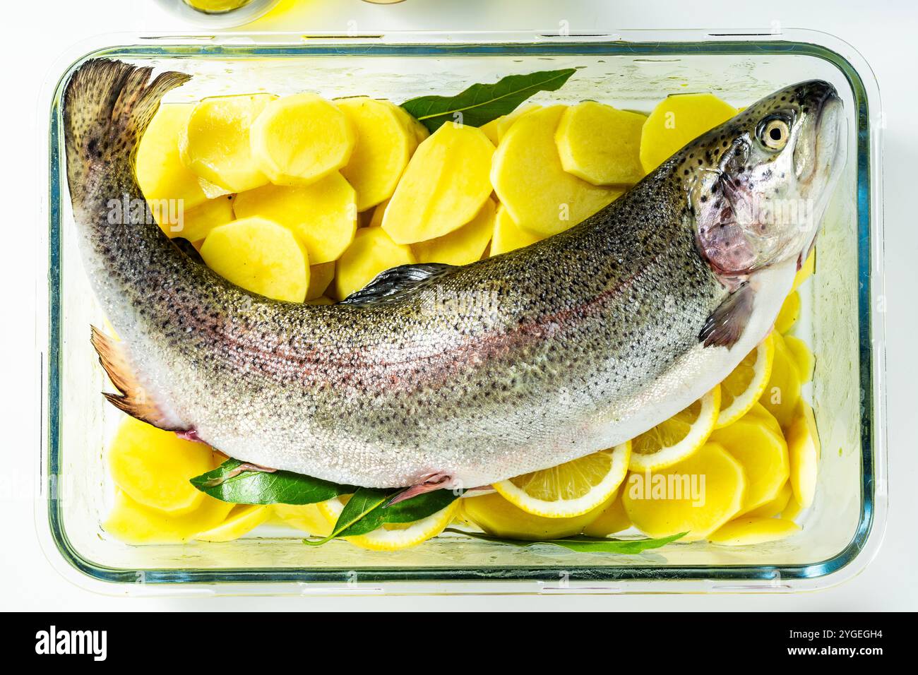 Salmon trout on the baking tray. Baking fish with potatoes Stock Photo ...
