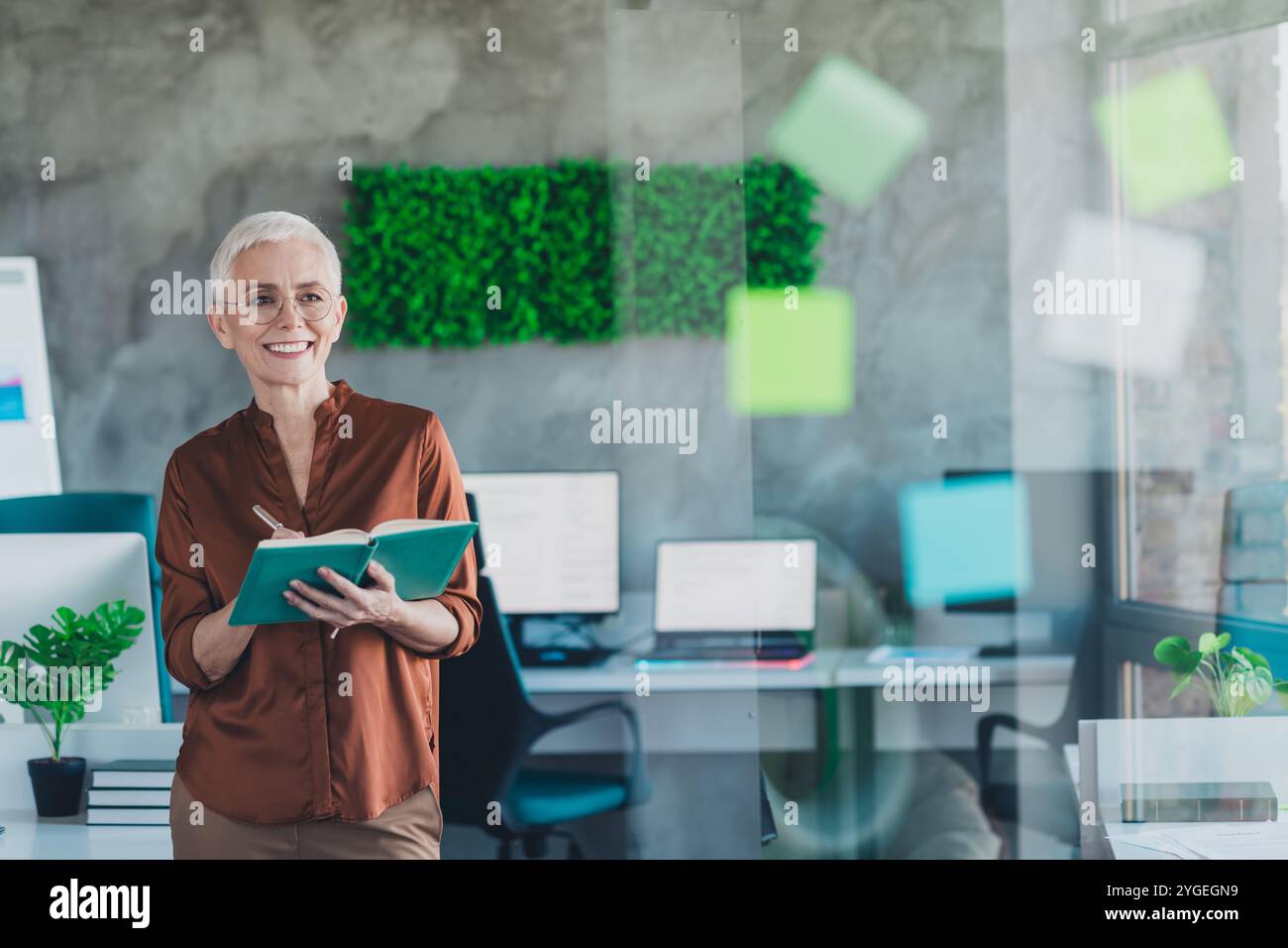 Photo of senior businesswoman stickers ideas write notebook wear brown ...