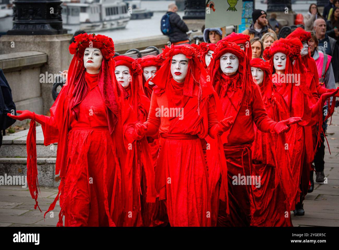The 'Red Rebel Brigade' group of environmental protesters in red robe ...