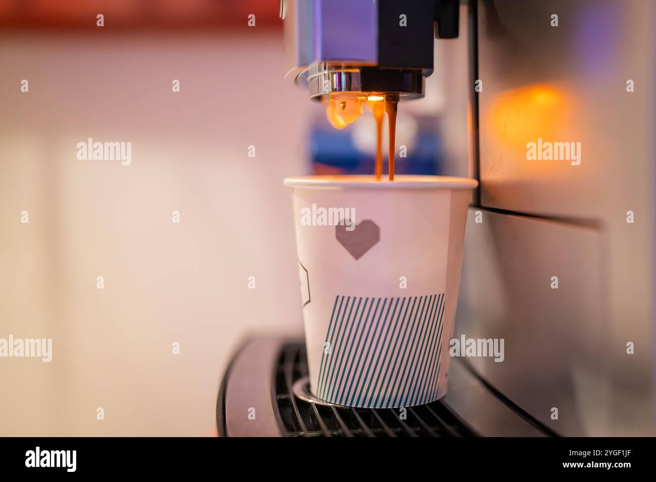 Coffee machine makes coffee in a paper cup at a public event, banquet ...