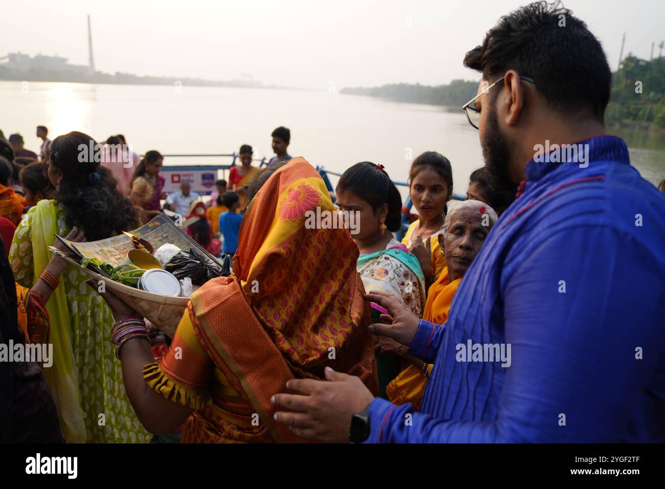 Kolkata, India - Nov 7, 2024: Hindu devotees gathered along the Hooghly ...
