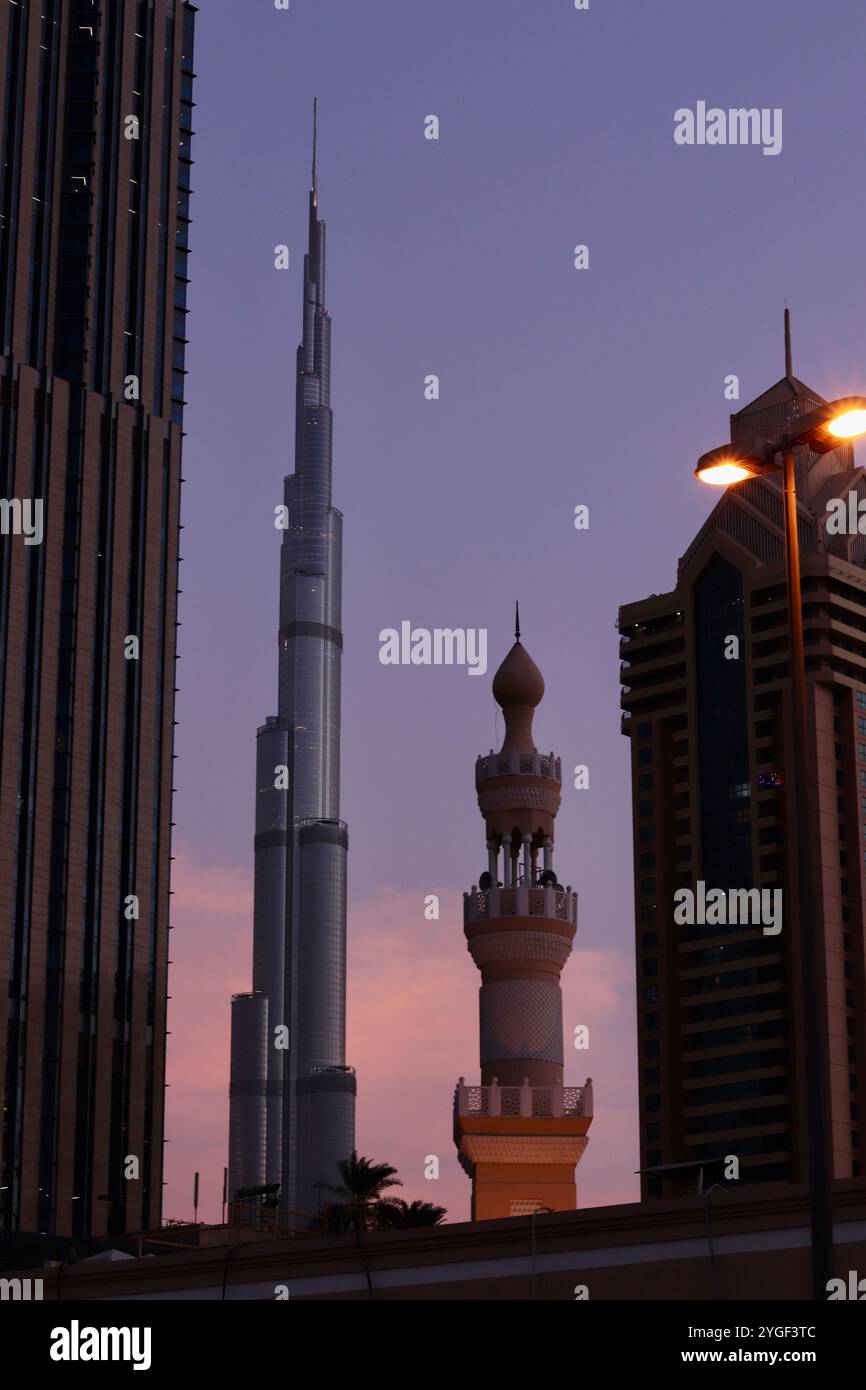 Twilight view of the Burj Khalifa in Dubai, towering over a traditional ...