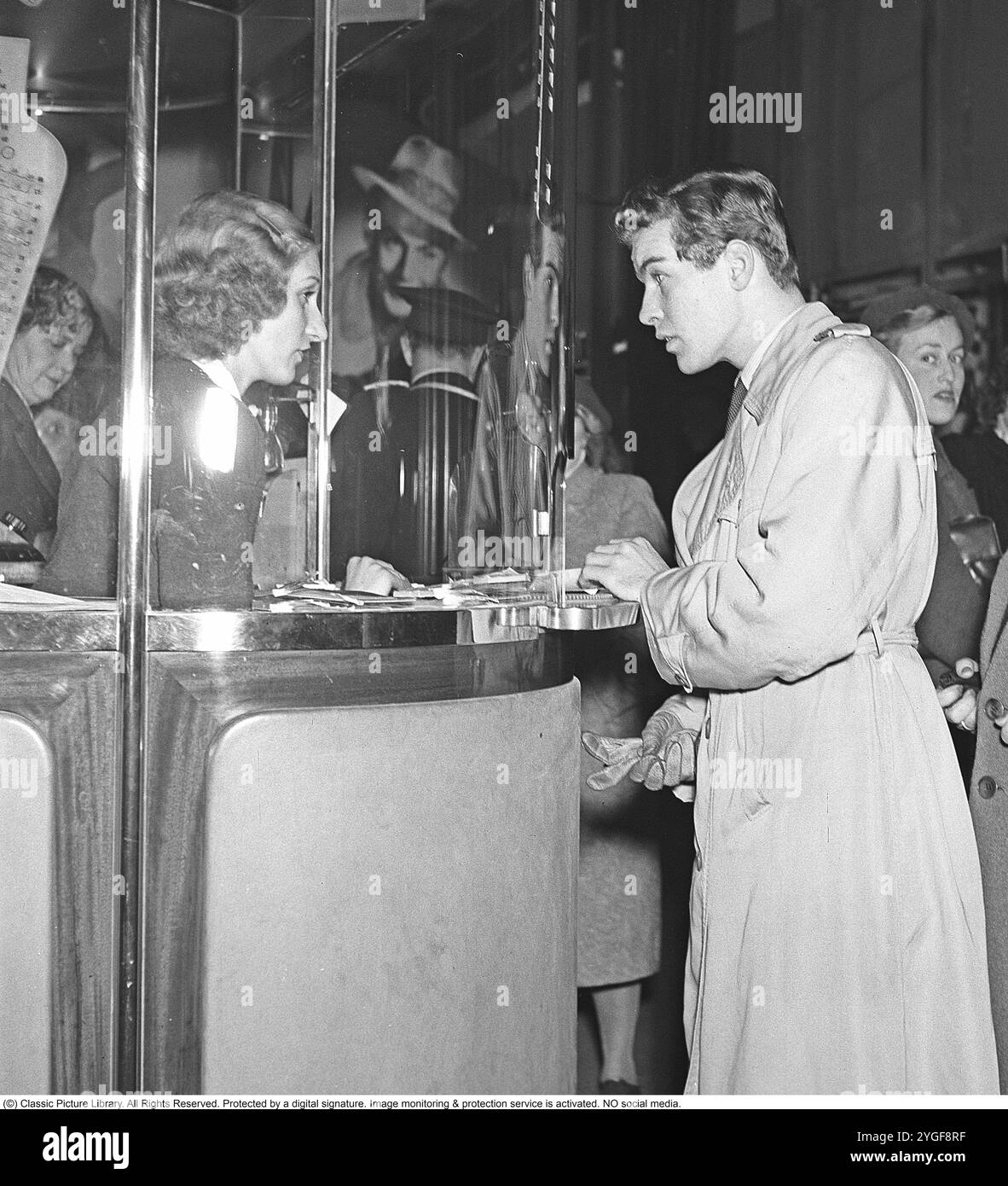 At the cinema 1944. A man in front of the cashier to buy tickets to the film. He is actor ...