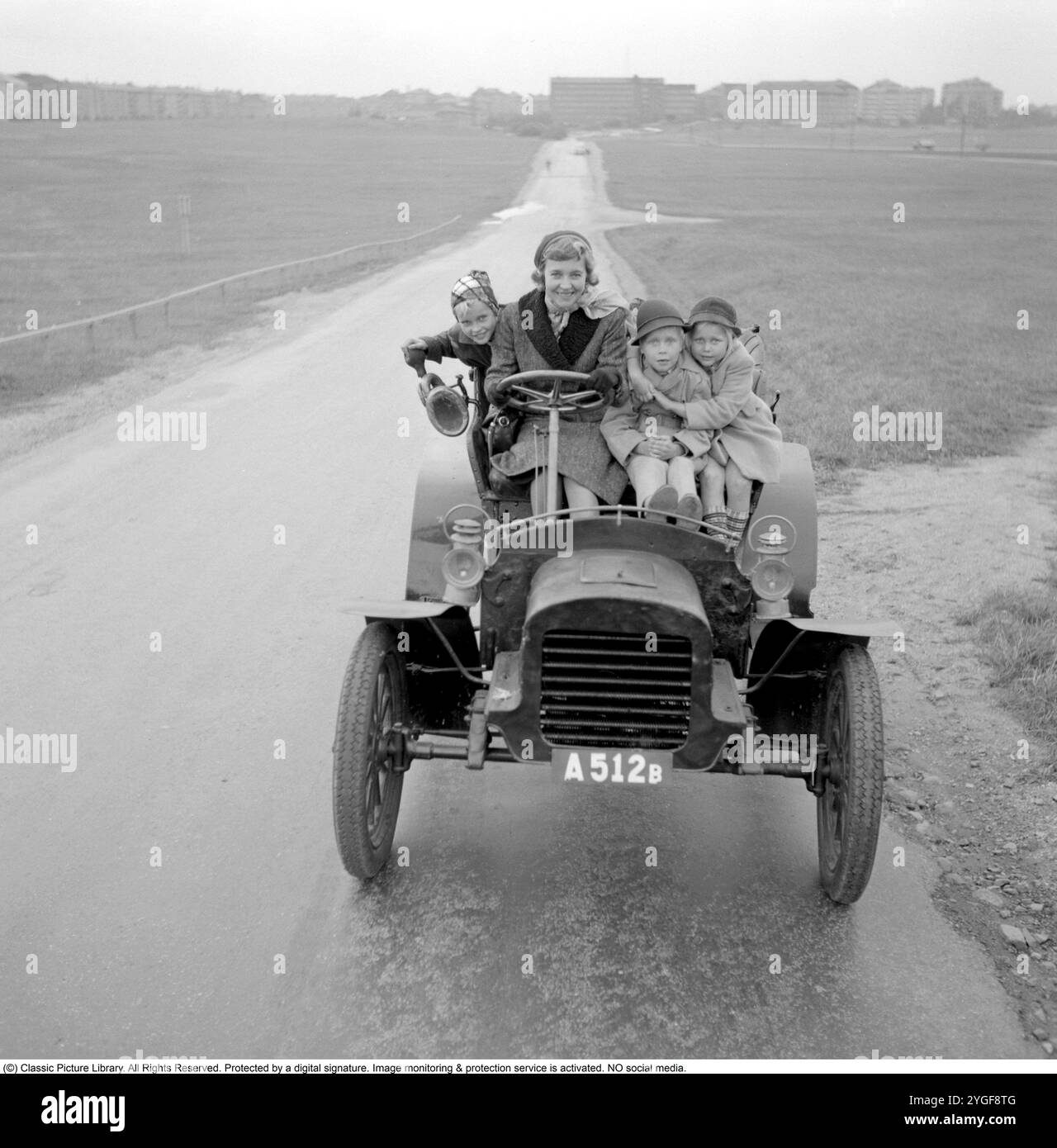 The vintage car 1955. The mother and her three children are seen in an ...