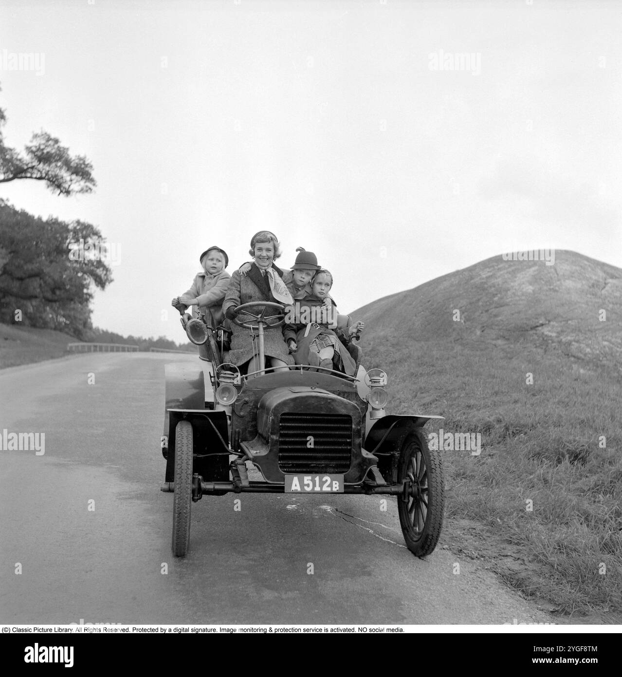 The vintage car 1955. The mother and her three children are seen in an ...