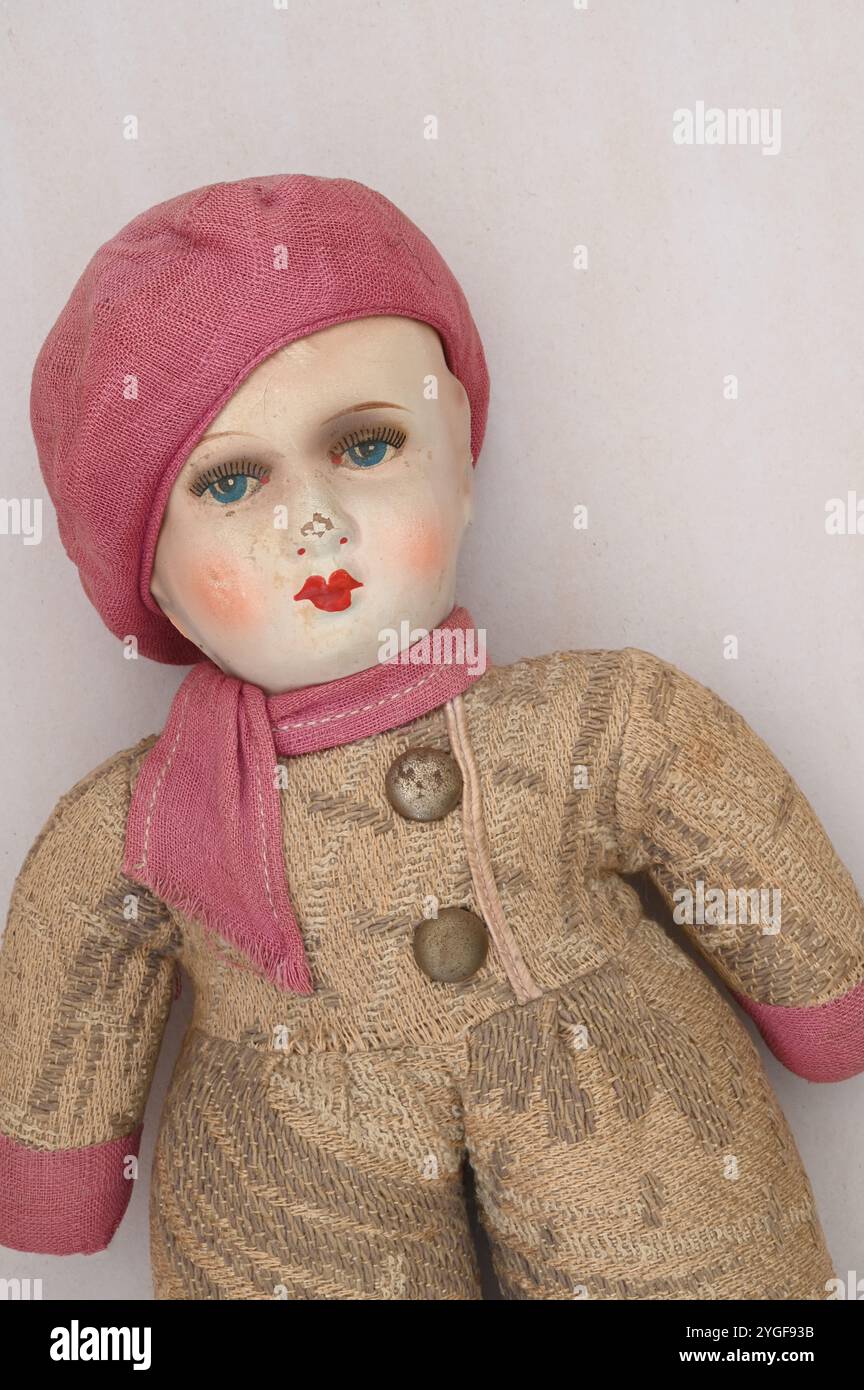 1930s doll of woman or girl wearing hat and scarf and bored or superior ...