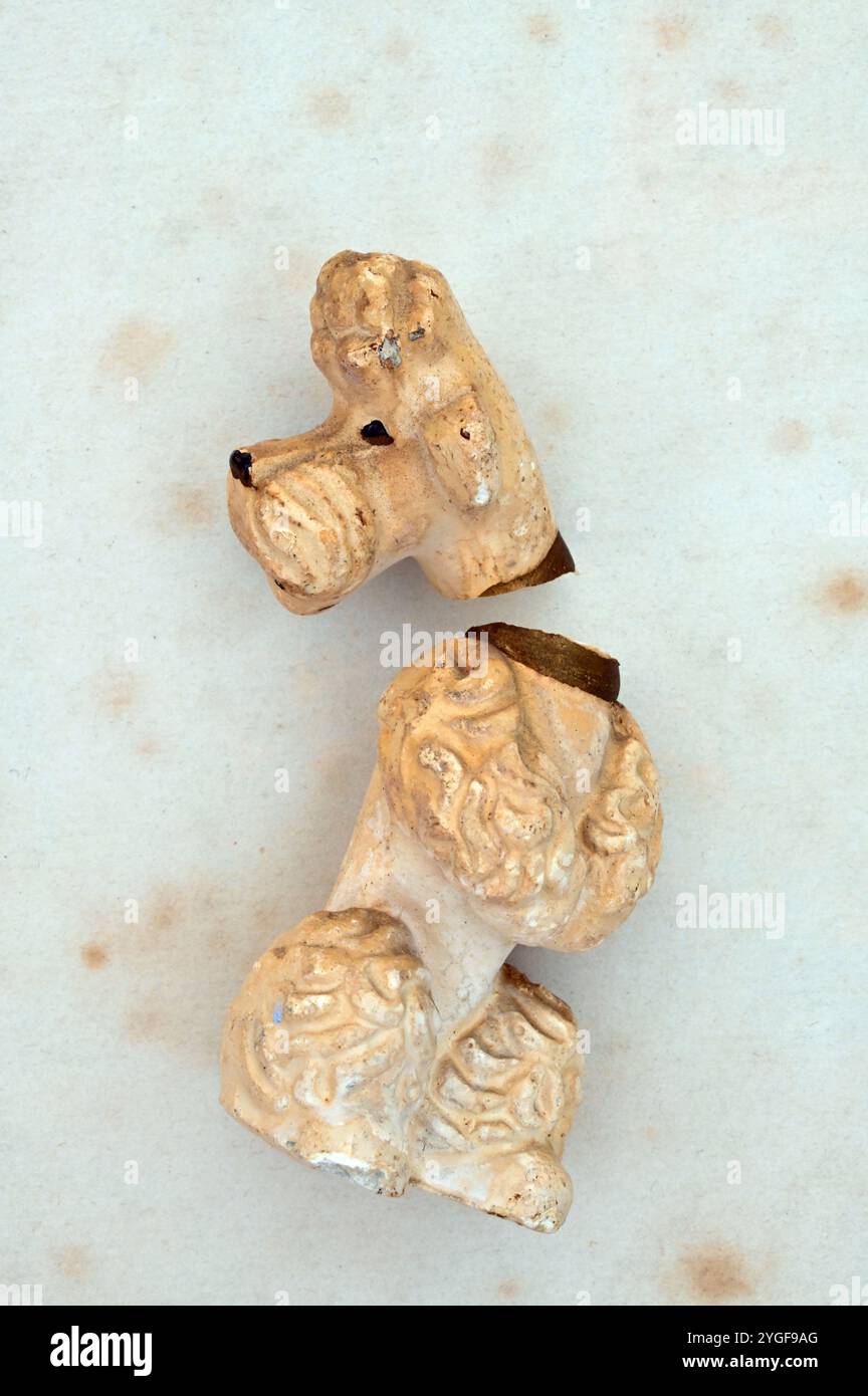 Plaster model of Poodle dog with its head broken off lying on antique ...