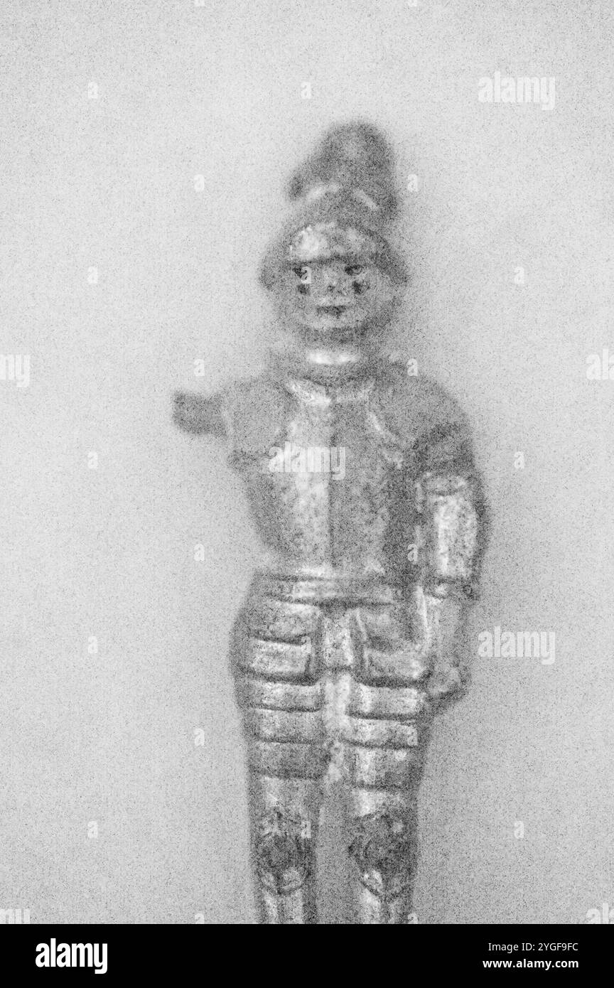 Soft monochrome image of model of medieval knight in armour with one ...