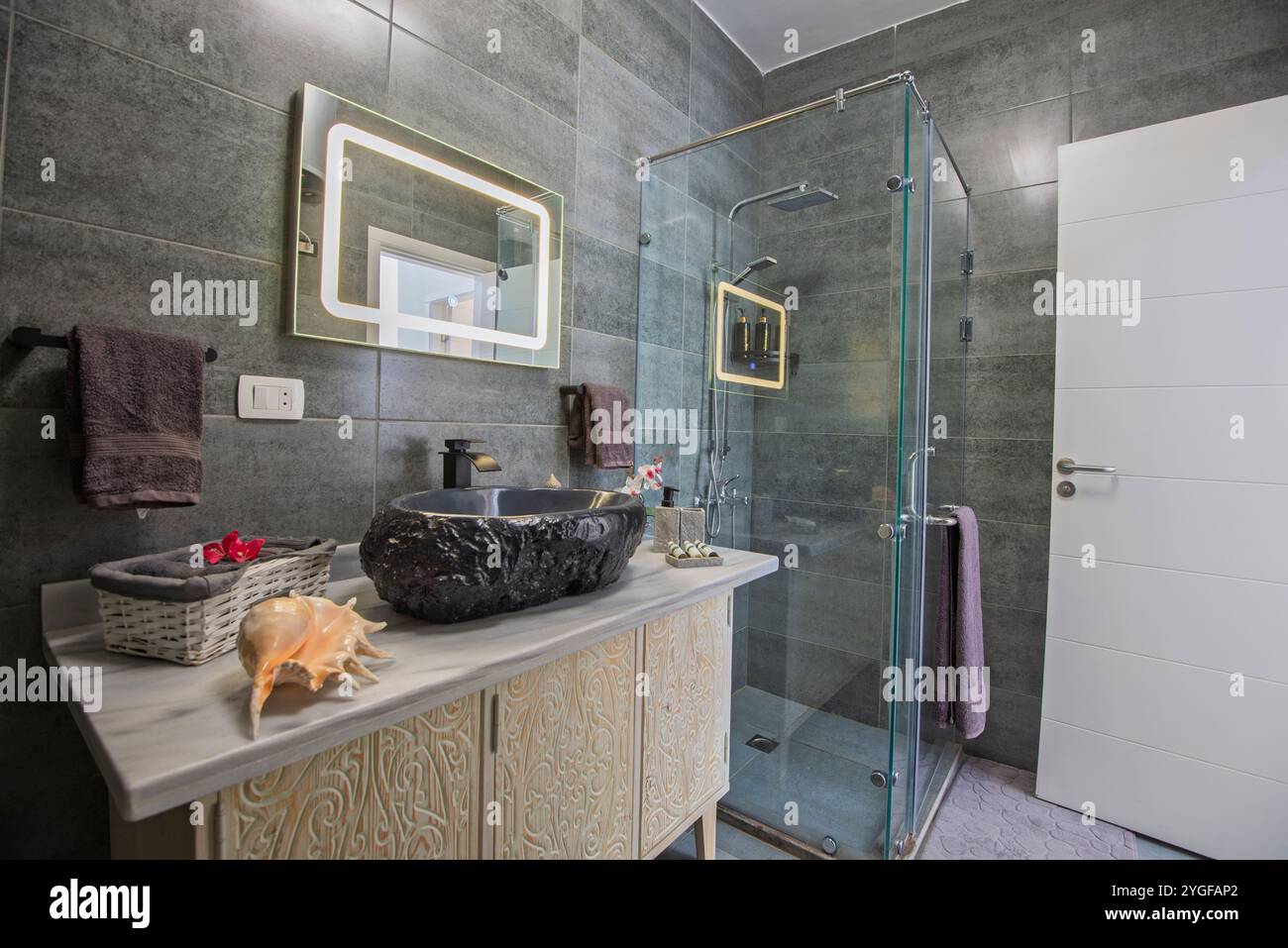 Interior design of a luxury show home bathroom with stone sink effect ...