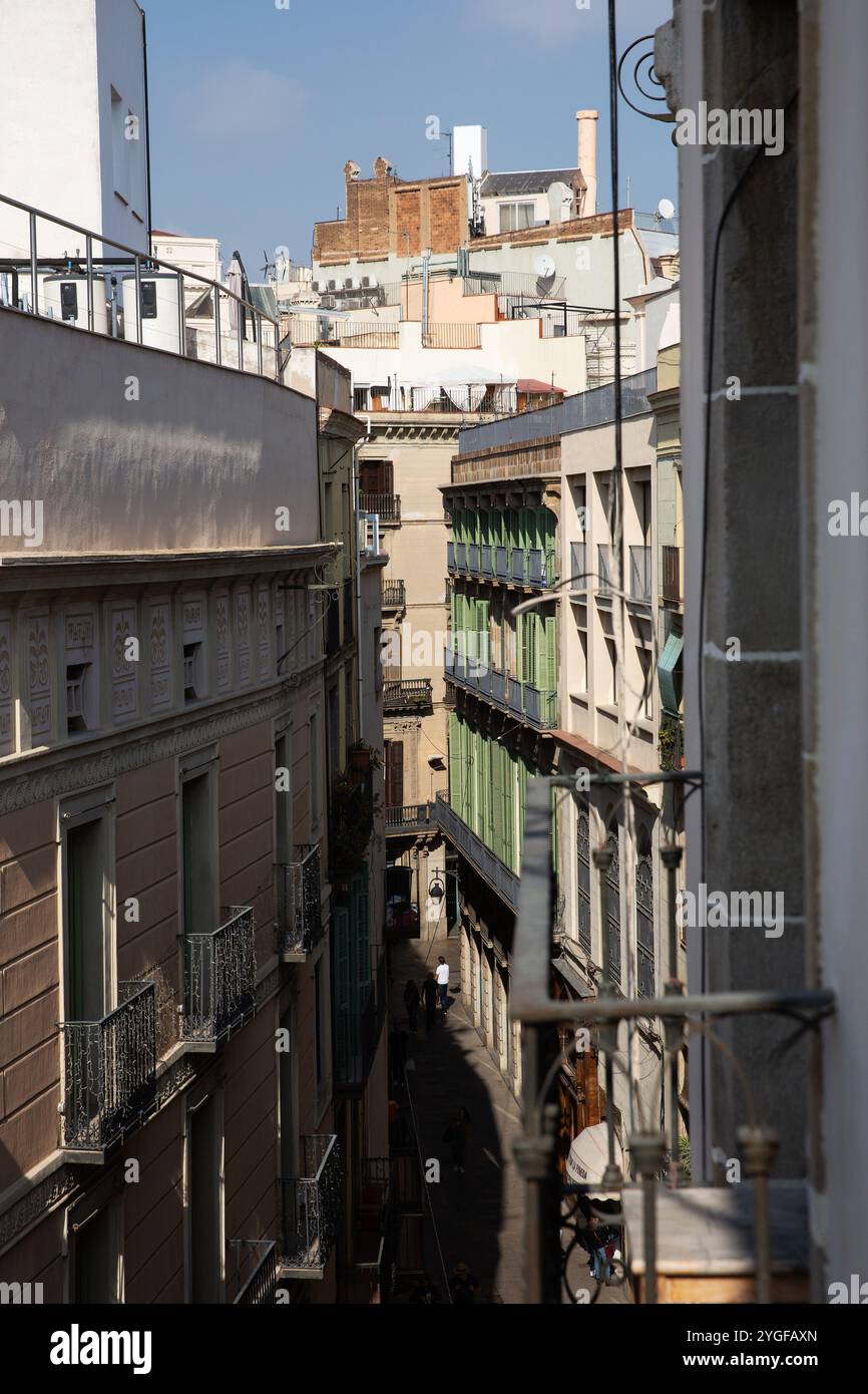 Narrow alleyway in Barcelona’s Gothic Quarter with charming balconies ...