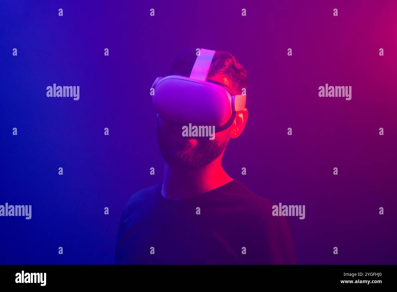 Man with VR headset in a colorful environment. Virtual reality goggles ...
