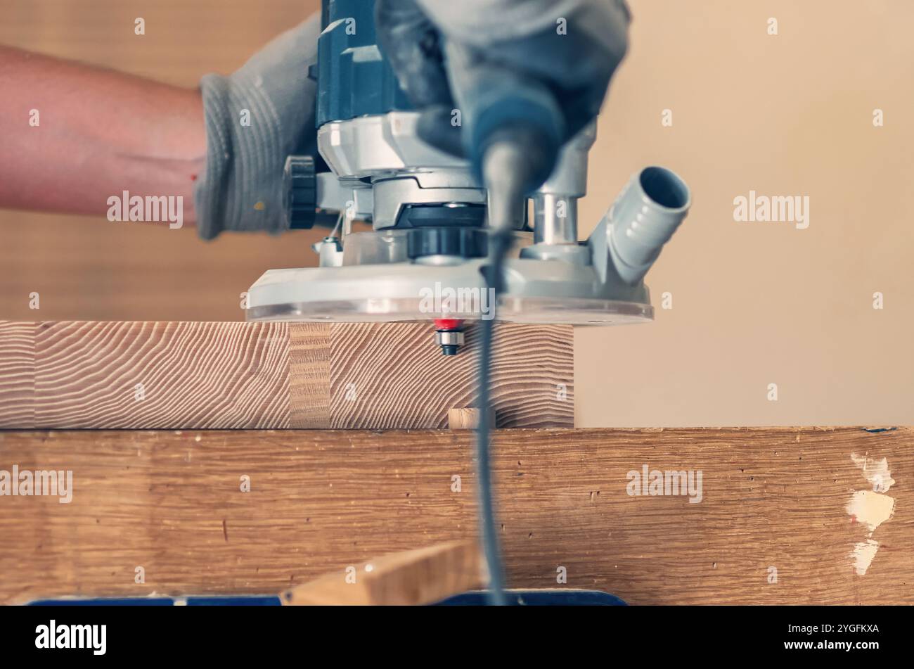 Hand router in action, finishing wooden board edges with expert ...