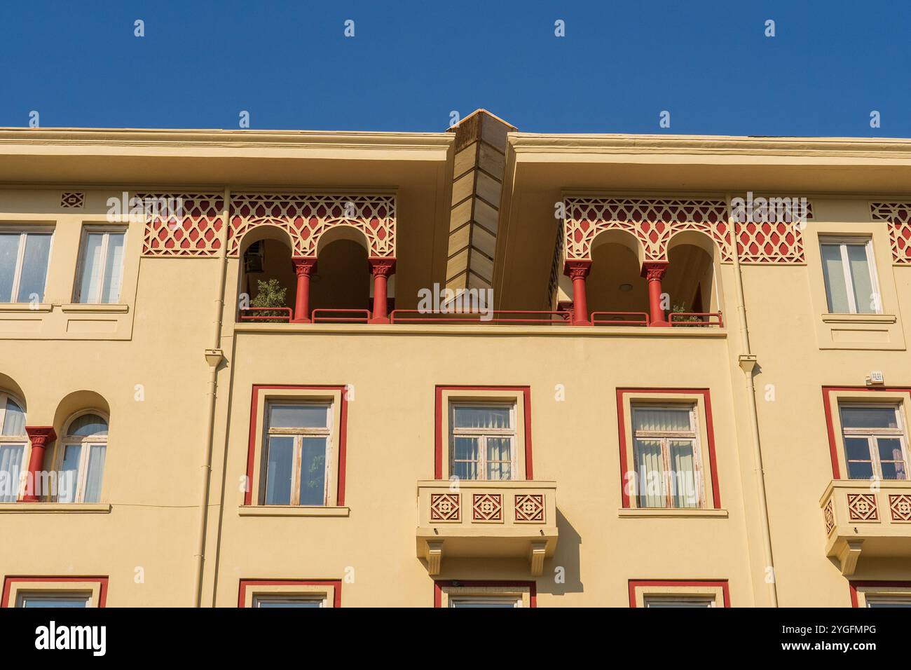 Vibrant Architecture with Red Pillars and Colorful Arch Frames on a ...