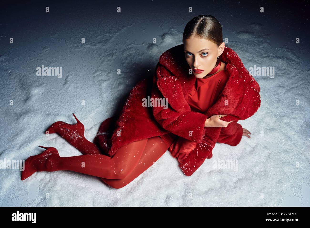 The striking woman in crimson attire showcases a chic winter look ...