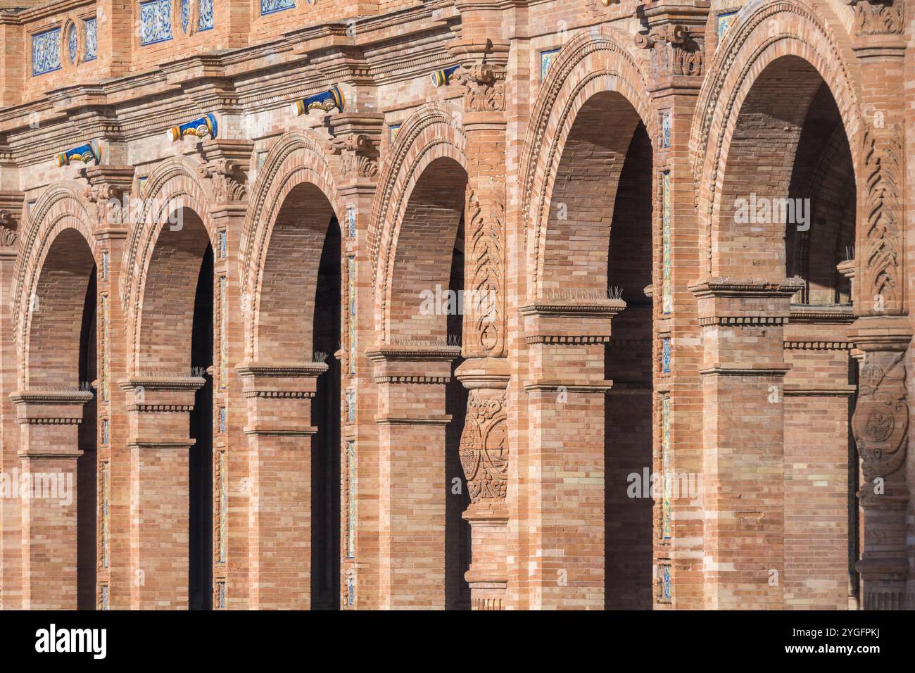 Close up view of the ornate brick arches at Plaza de España in Seville ...
