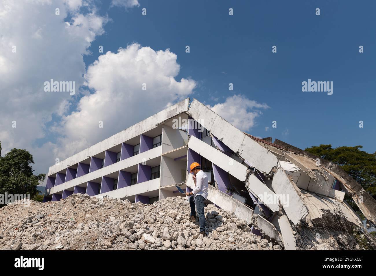 Engineer holding tablet is checking for destruction, demolishing ...