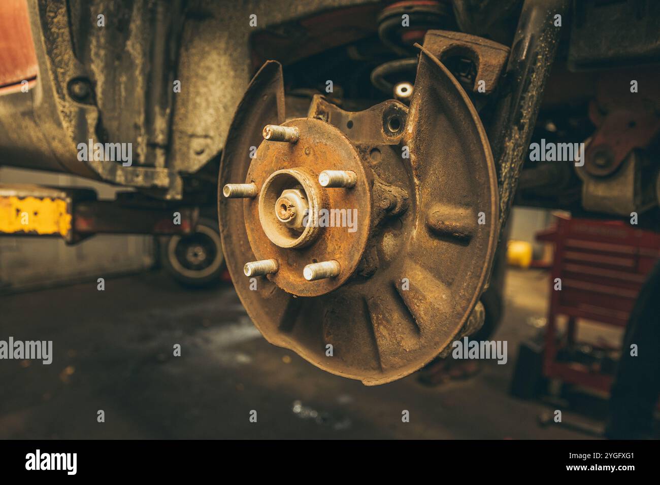 Rusty brake rotor in Auto Repair Shop Car on Lift Stock Photo - Alamy