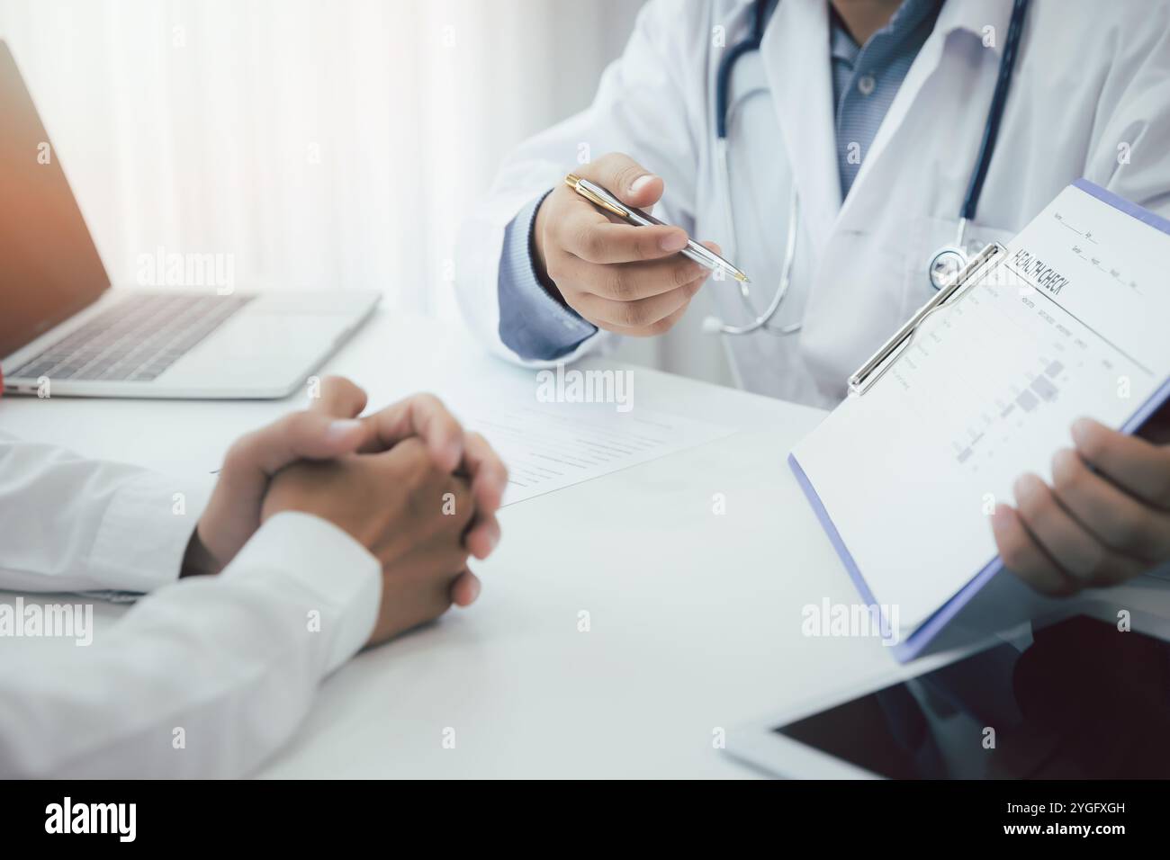 A doctor consulting and explain patient health check in office ...