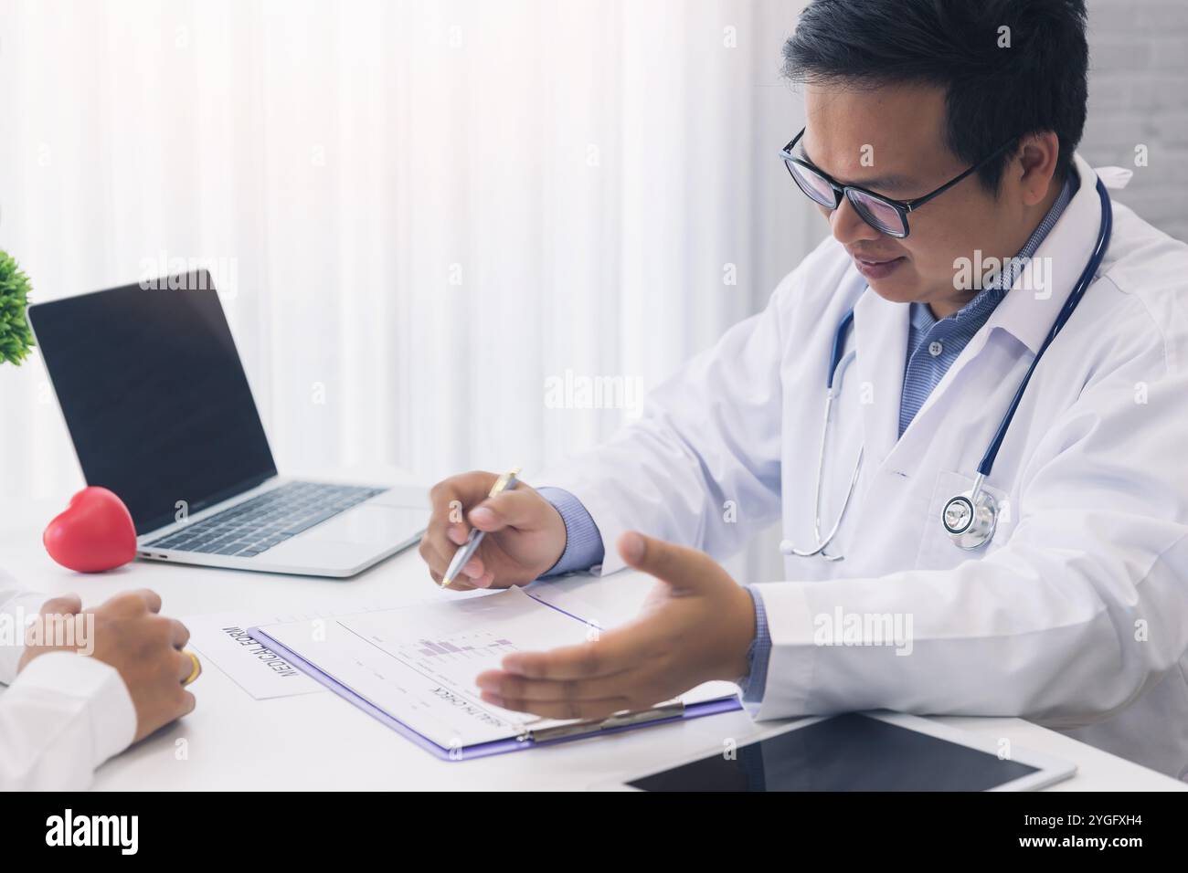 A doctor consulting and explain patient health check in office ...
