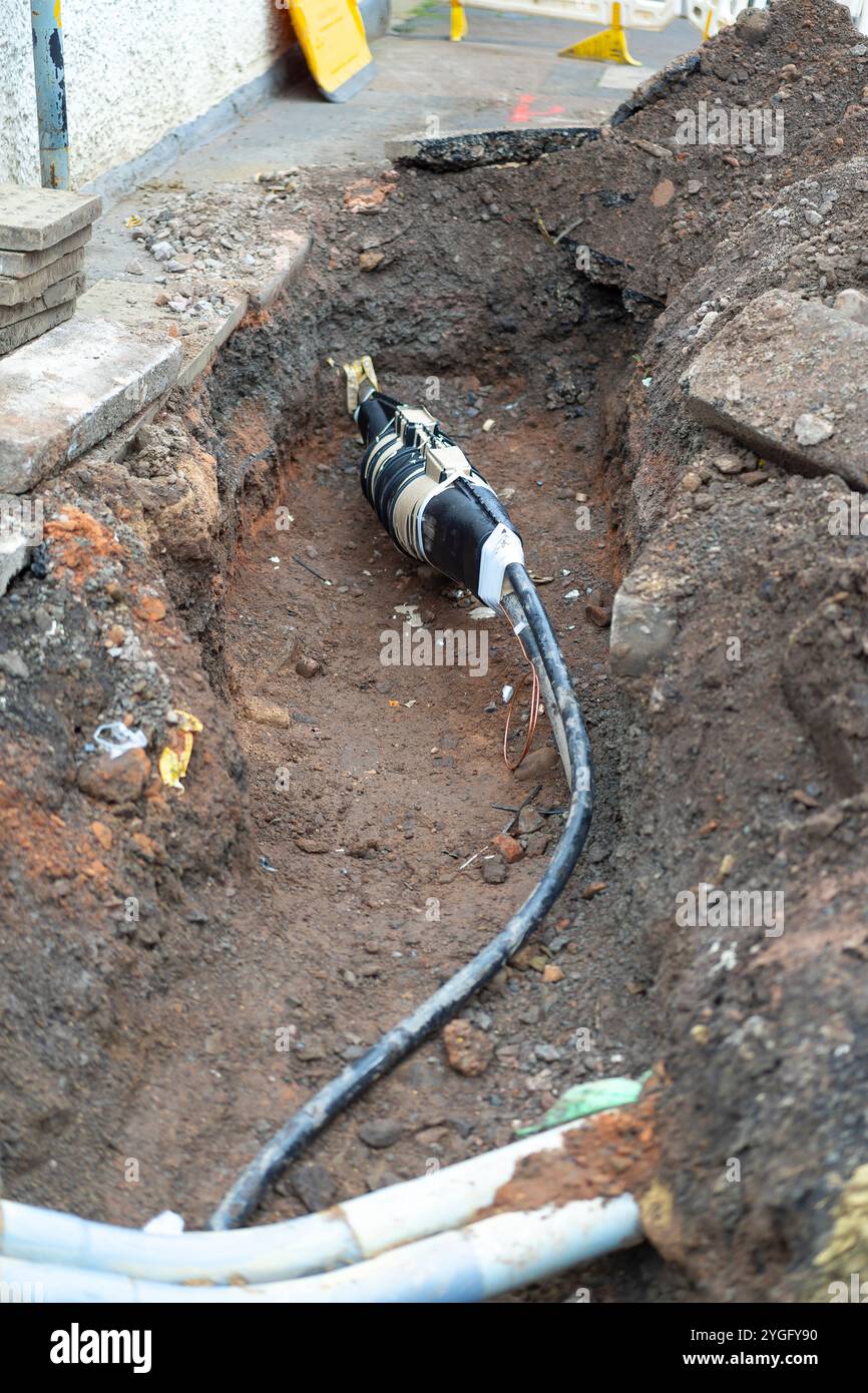 Underground electrical cables spliced together and sealed with a ...