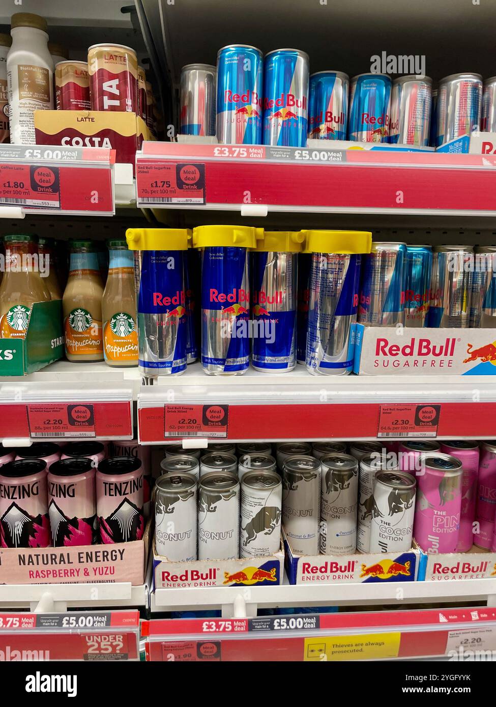 cans of red bull energy drink with anti-theft security tags in a ...
