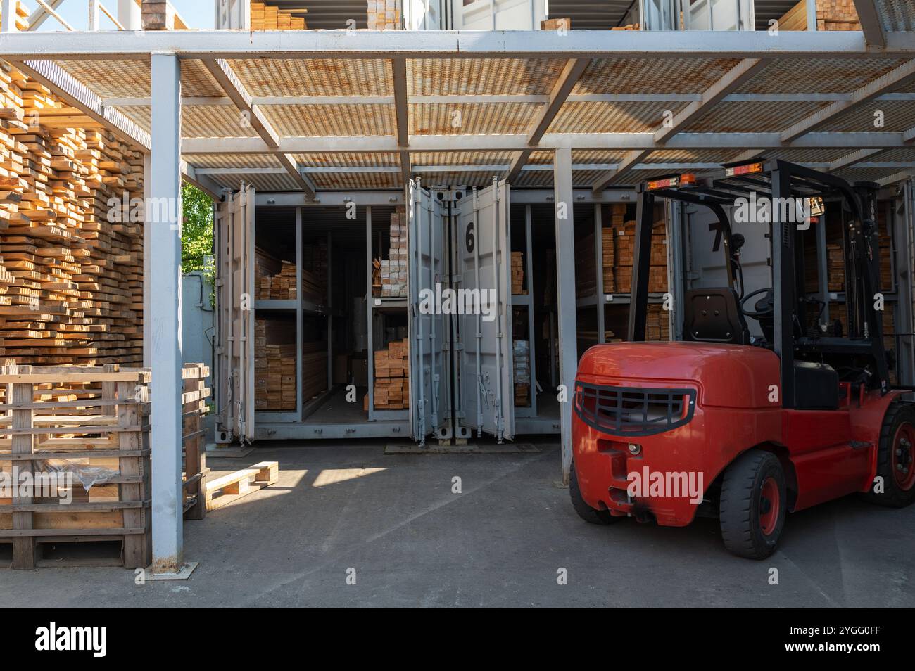 Industrial warehouse scene with a red forklift parked near shipping ...