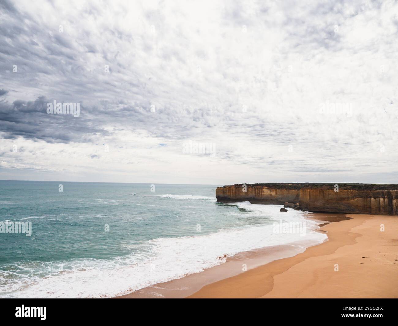 Beach along the Great Ocean Road, Australia, with towering cliffs and turquoise waters ...