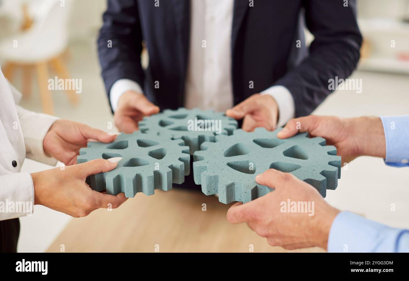 Business Team Holding Gears Representing Collaboration And Partnership ...