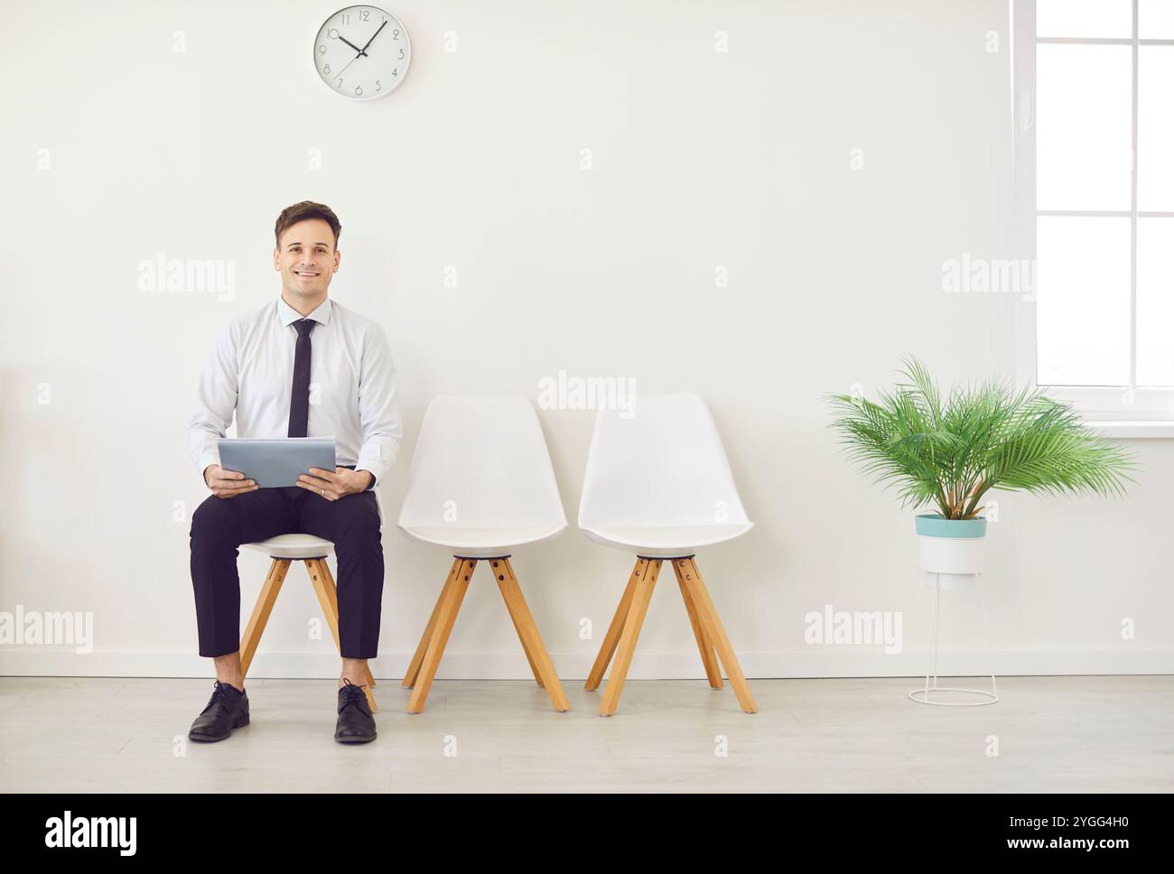 Job seeker sitting in a row with empty chairs waiting for interview ...