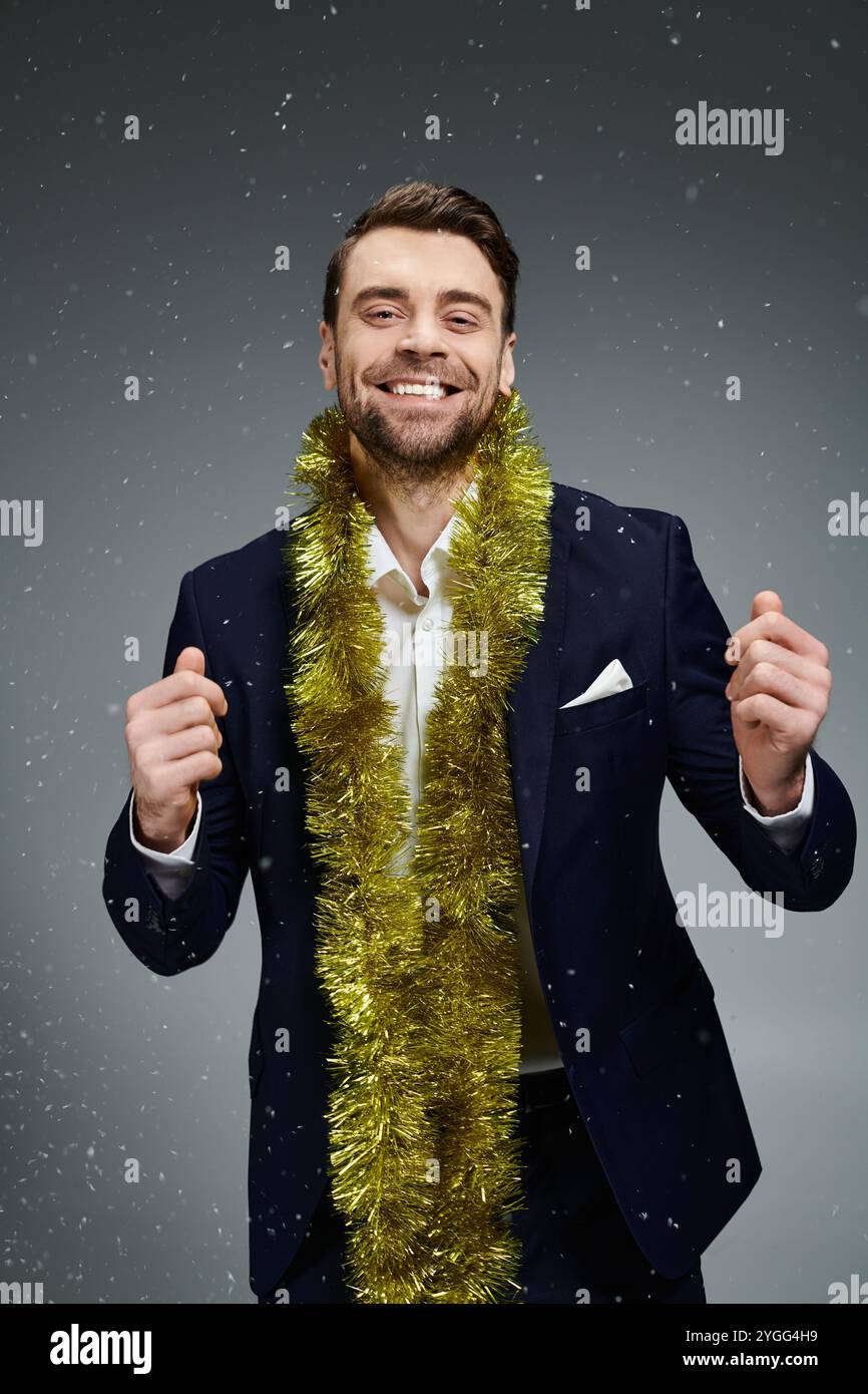 A smiling young man dressed elegantly with a festive garland radiates ...