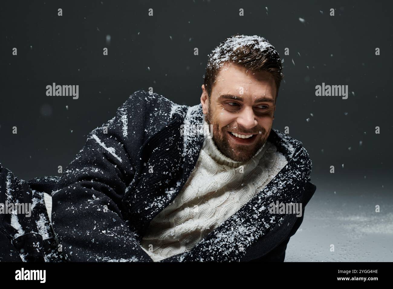 A cheerful young man enjoying a playful moment while surrounded by ...