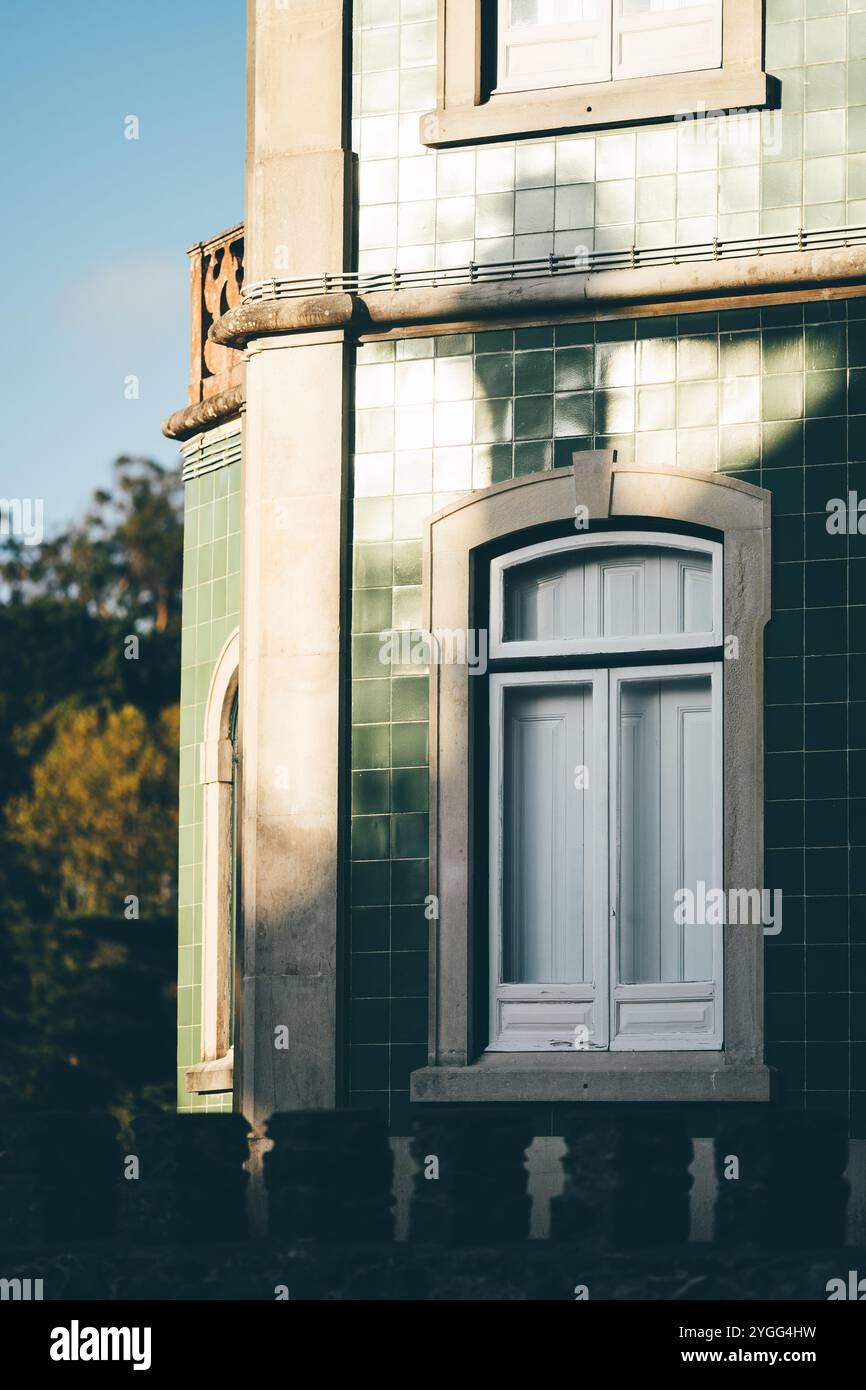 Facade of a historic building with green ceramic tiles, intricate ...