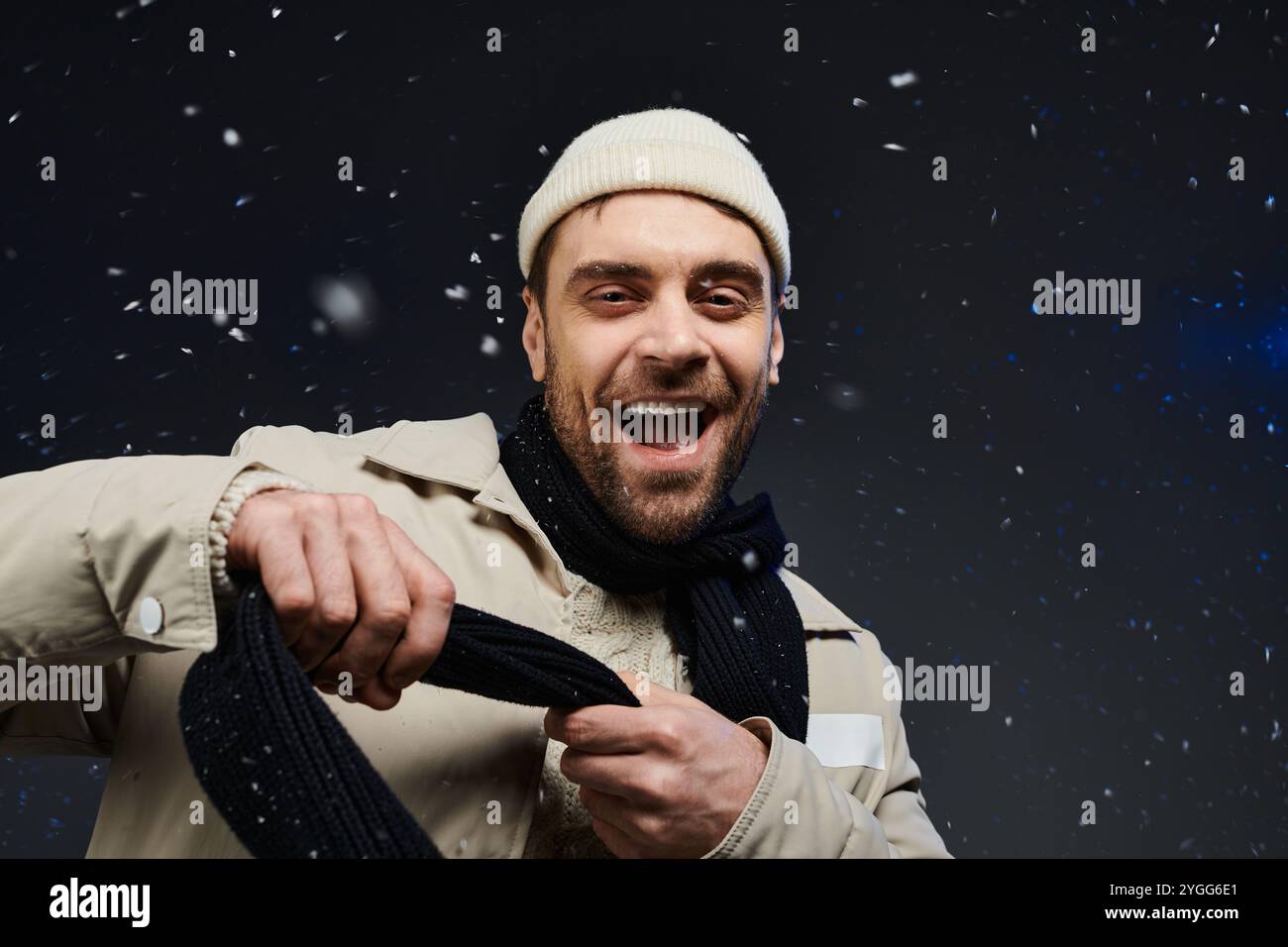 The young man beams with joy, wrapped in a cozy scarf amidst falling ...