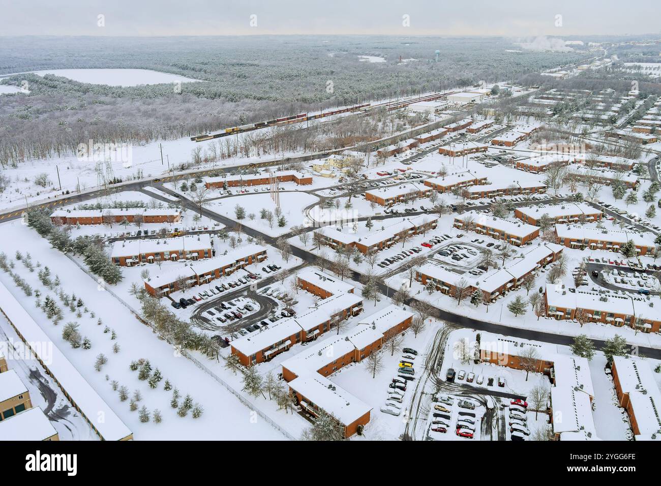 An aerial view of winter American suburbs shows areas covered in snow ...