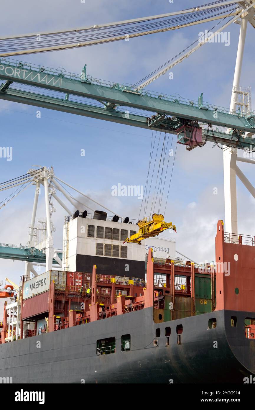 Miami, Florida, USA - 1 December 2023: Crane unloading a container ship ...