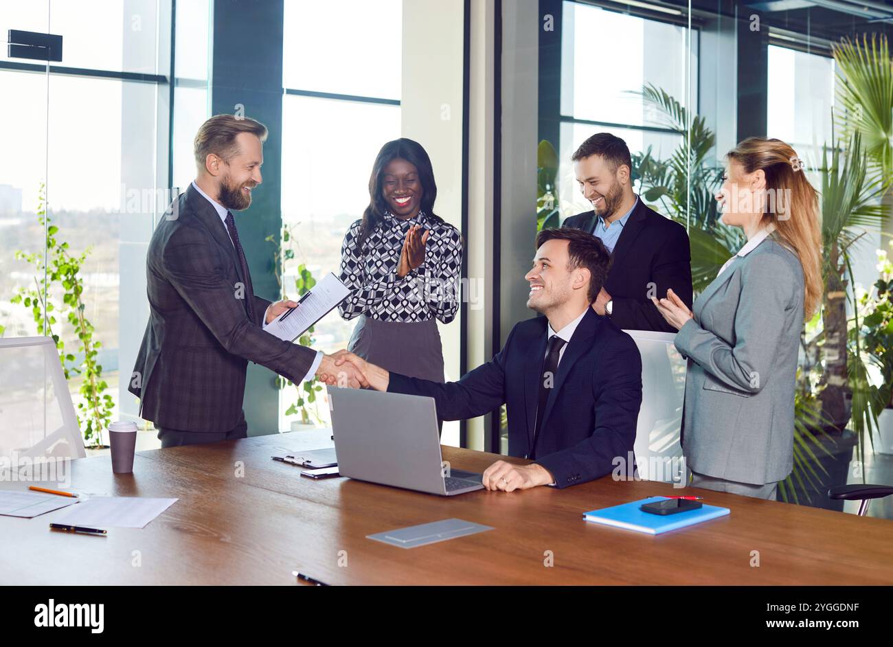 Boss Shaking Hands With Employee Amidst Colleagues Celebrating Success ...