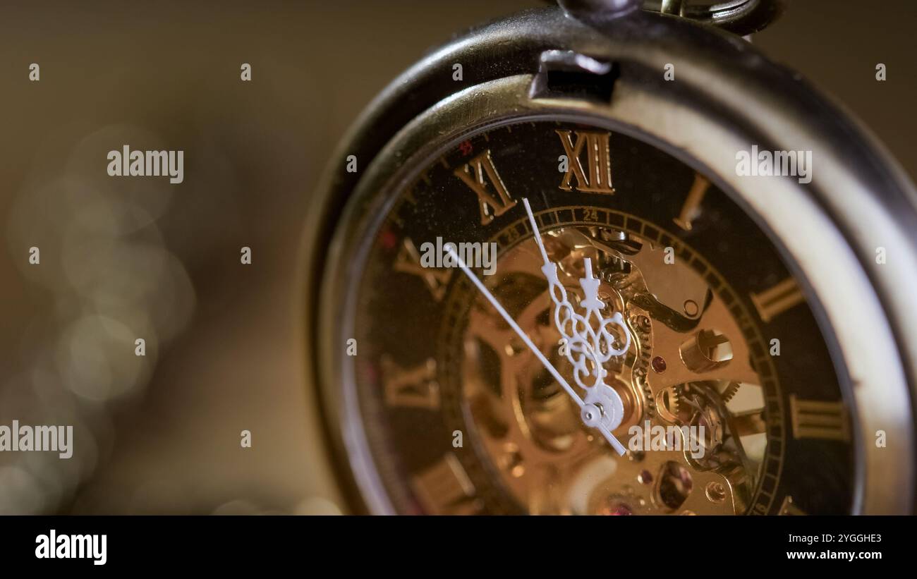 Golden antique elegant pocket watch ticking, five minutes to midnight ...