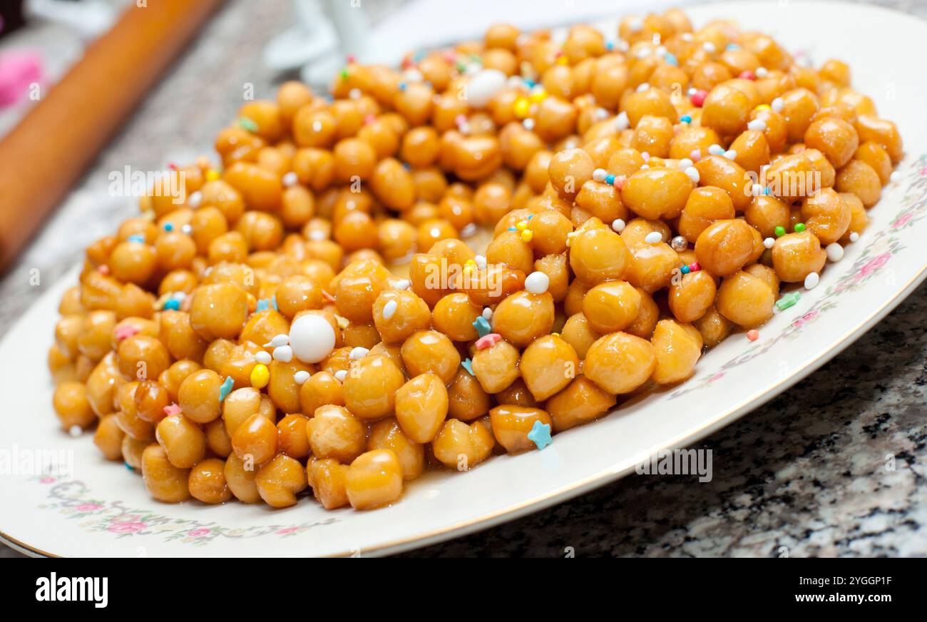 Neapolitan struffolis with honey in the pot Stock Photo - Alamy