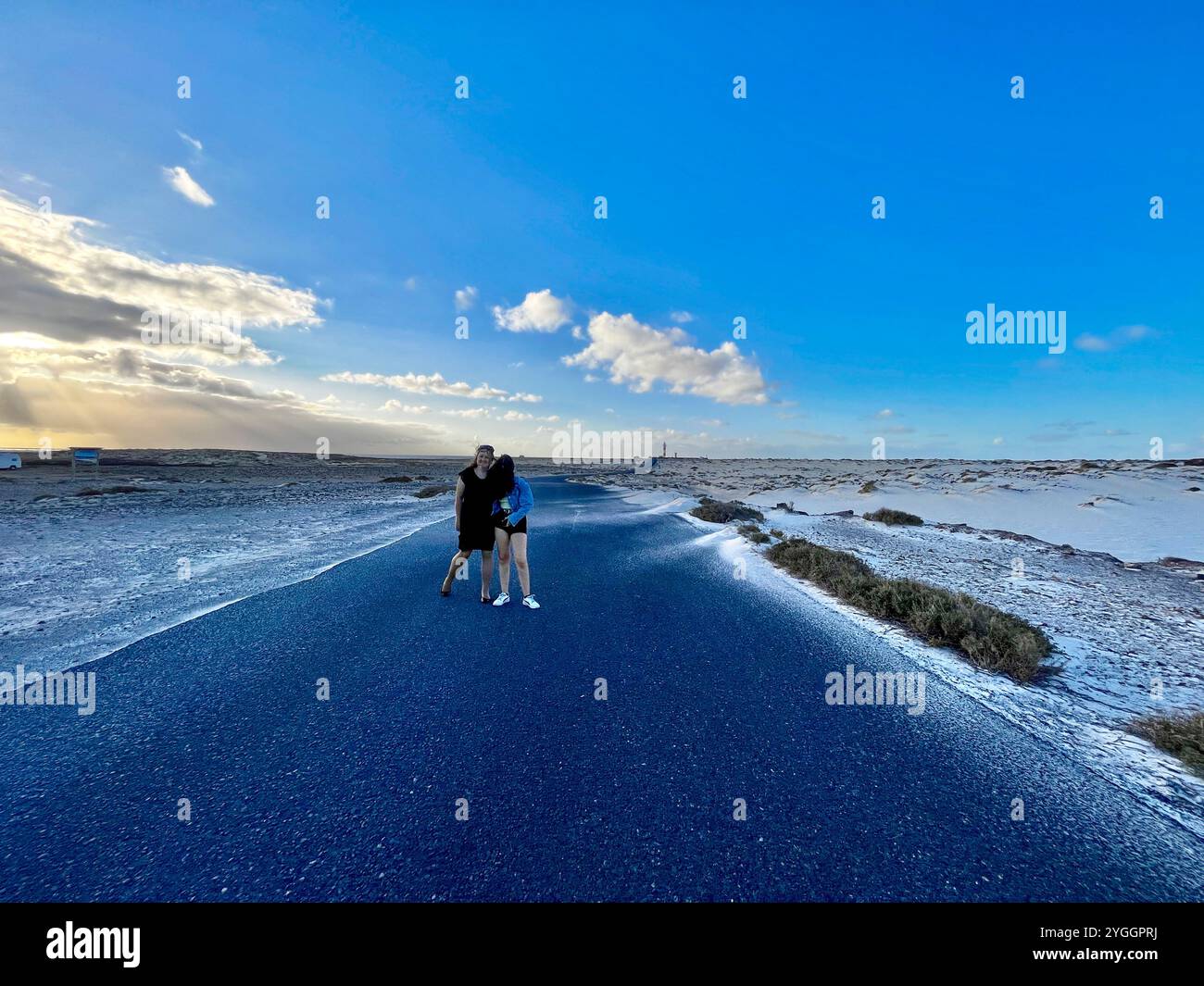 two women on a windy road at dusk Stock Photo - Alamy