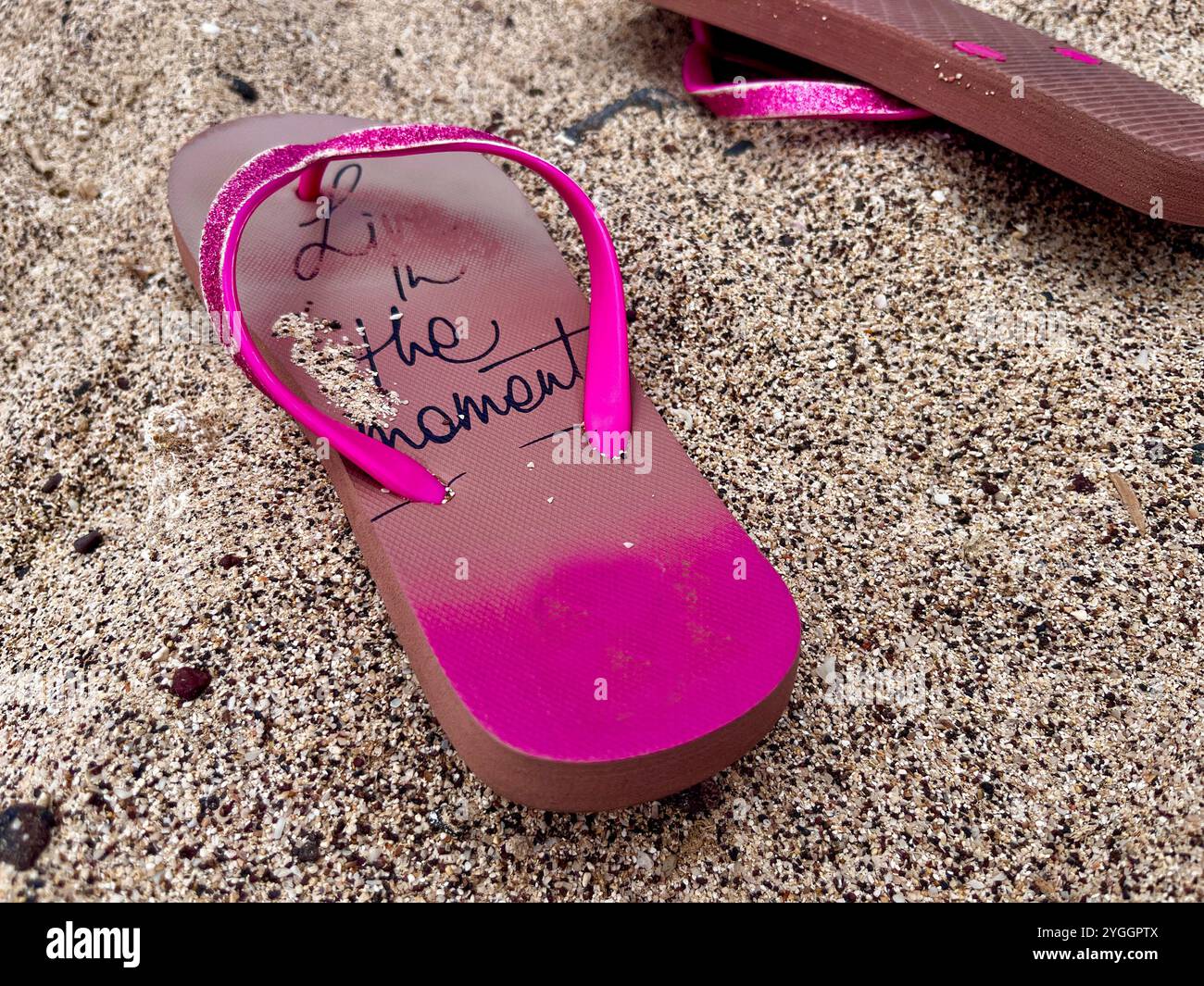 pink flip flop in beach sand Stock Photo - Alamy