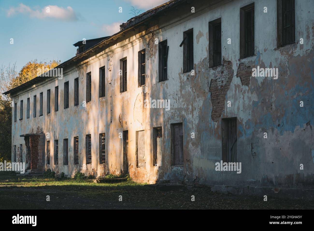 Boarded-up windows of an old abandoned building. Evening sunlight Stock ...