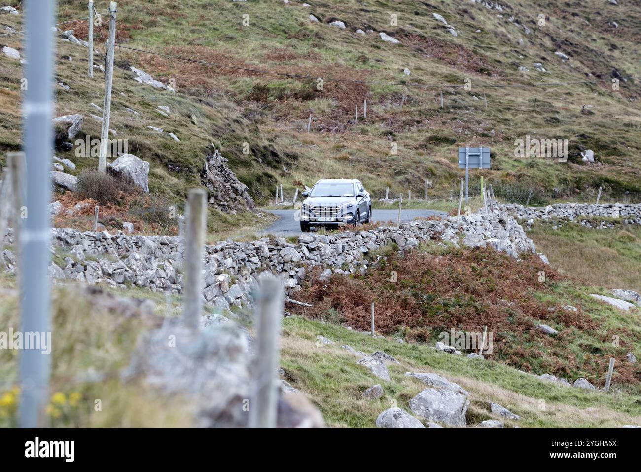 car driving along narrow twisty mountain road in rural donegal ...
